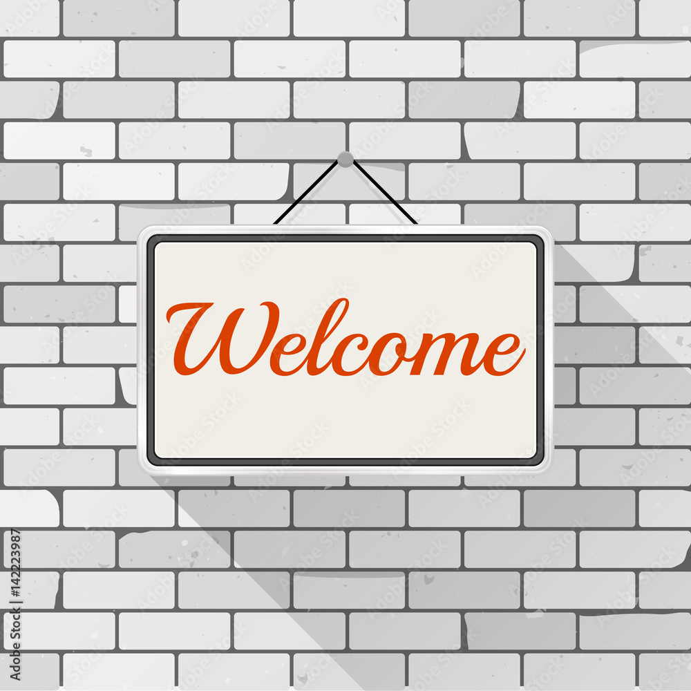 Simple white sign with text 'Welcome' hanging on a gray brick wall ...
