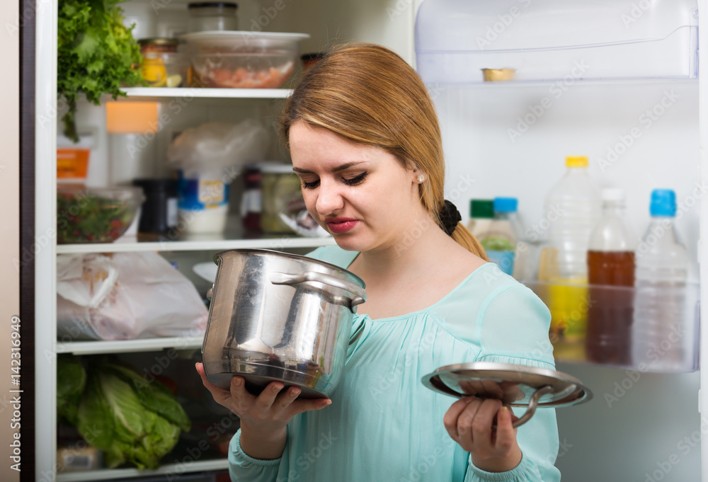 woman noticed foul smell of food from casserole Stock Photo | Adobe Stock