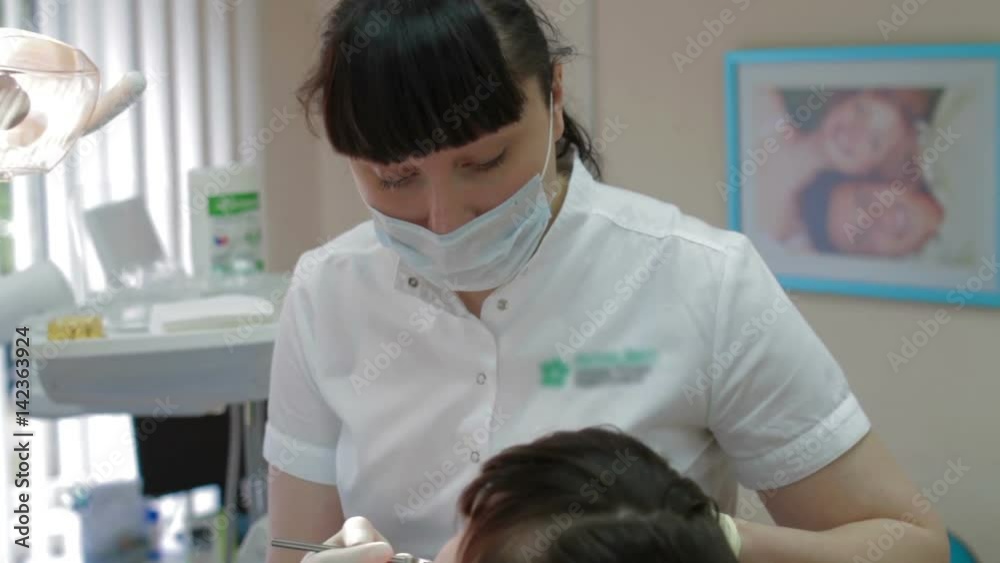Dentist fixing teeth patient in dental clinic Stock Video | Adobe Stock
