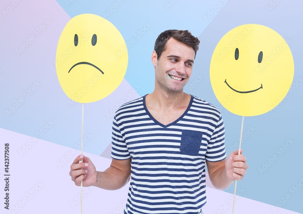 Man holding happy and sad face against blue background Stock Photo ...