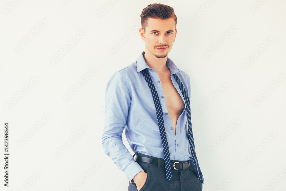 Confident Young Business Man in Unbuttoned Shirt Stock Photo | Adobe Stock