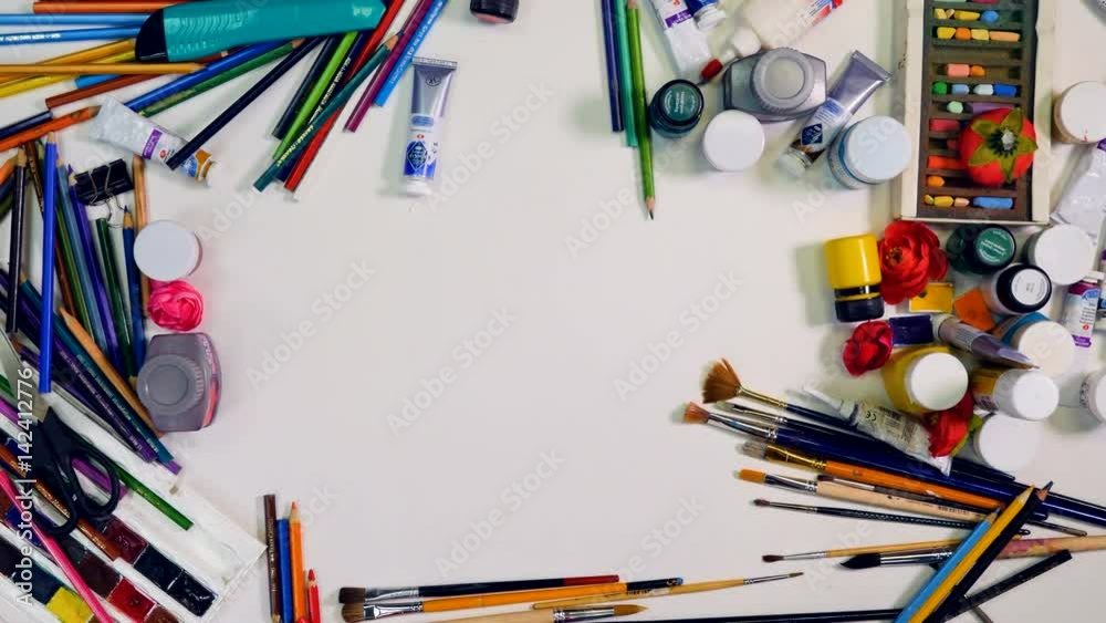 Designer, artist workspace. Hands remove objects on the table, leave ...