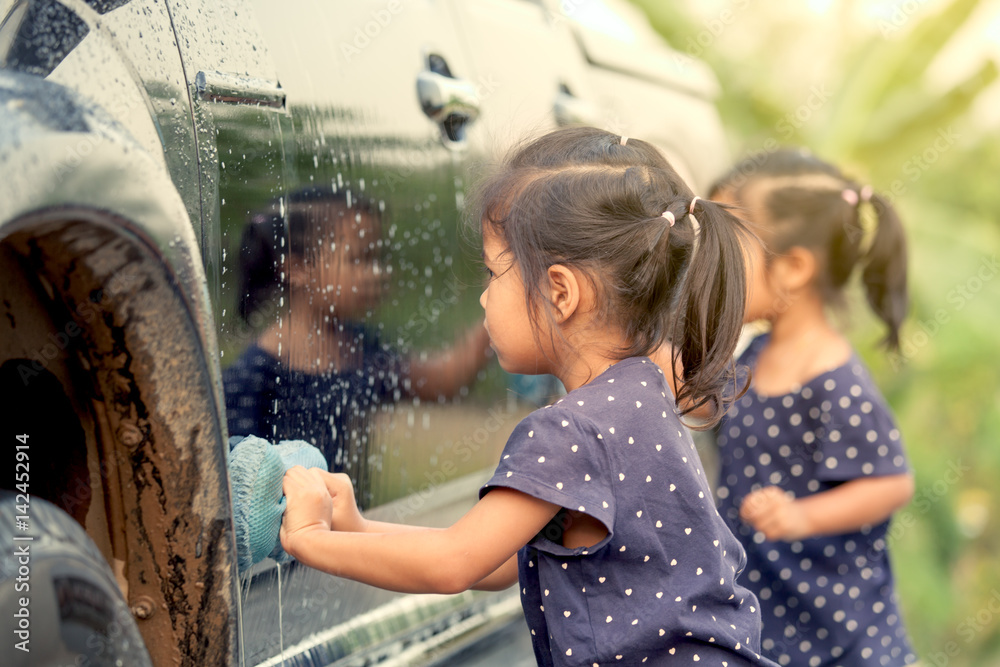 Cute asian little girl washing car in vintage color tone Stock Photo ...
