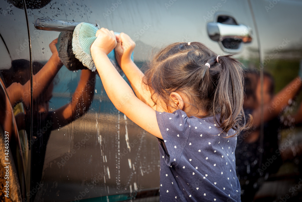 Cute asian little girl washing car Stock Photo | Adobe Stock