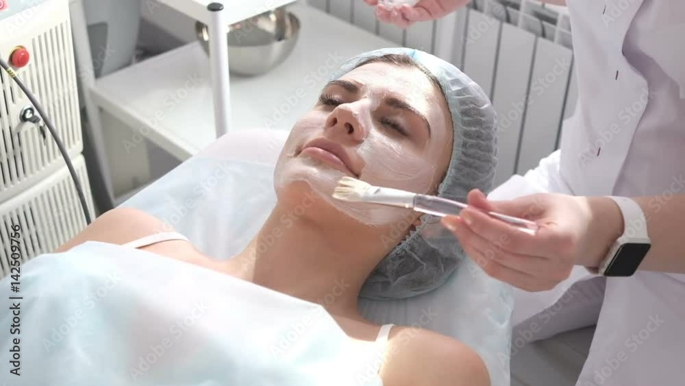 Young woman getting a cosmetic medicine treatment, close-up. Beautician ...