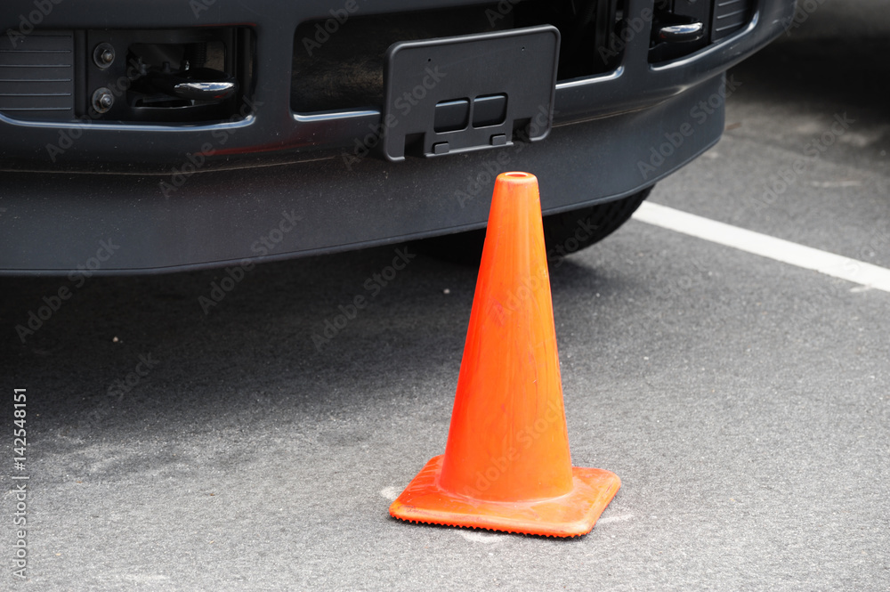 traffic warning cone put in front of vehicle Stock Photo | Adobe Stock