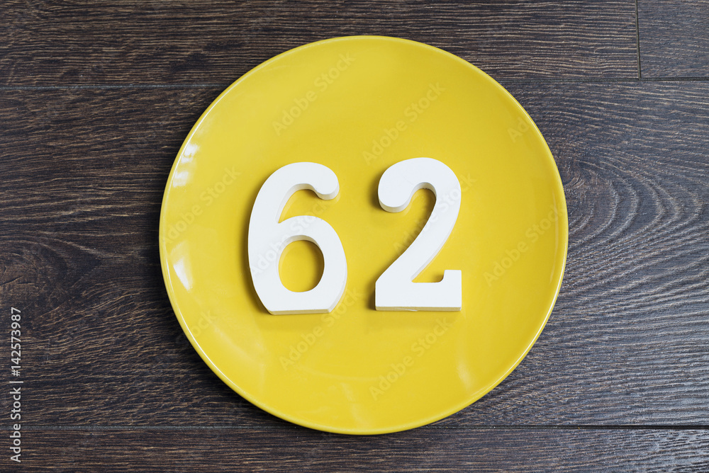 The number sixty-two on the yellow plate. Stock Photo | Adobe Stock