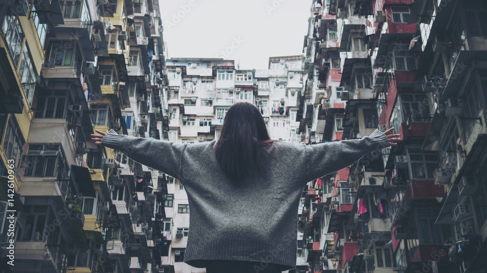 Image of a woman turn her back and stretched her arms with a crowded ...