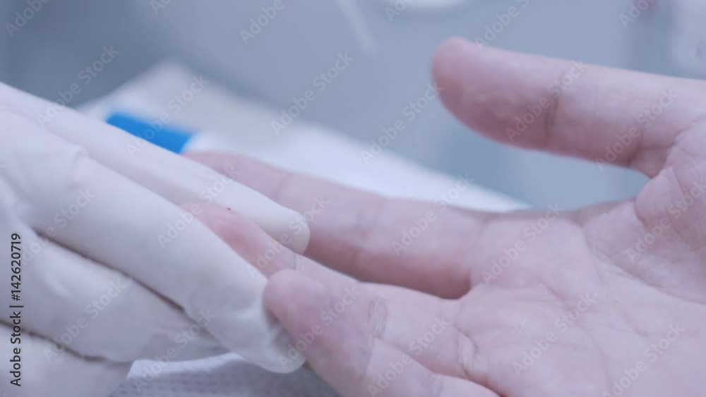 Doctor hand take blood test from patinent finger at lab. Close up of ...