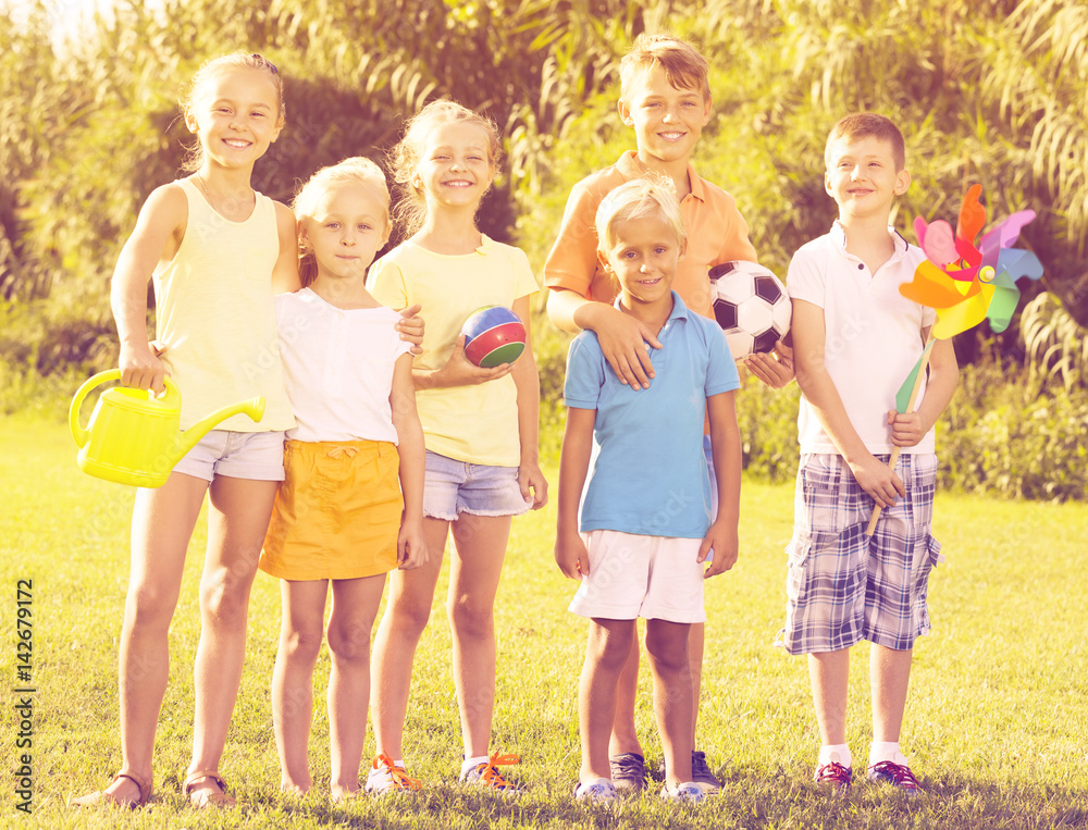 children standing outdoors on sunny day. Stock Photo | Adobe Stock