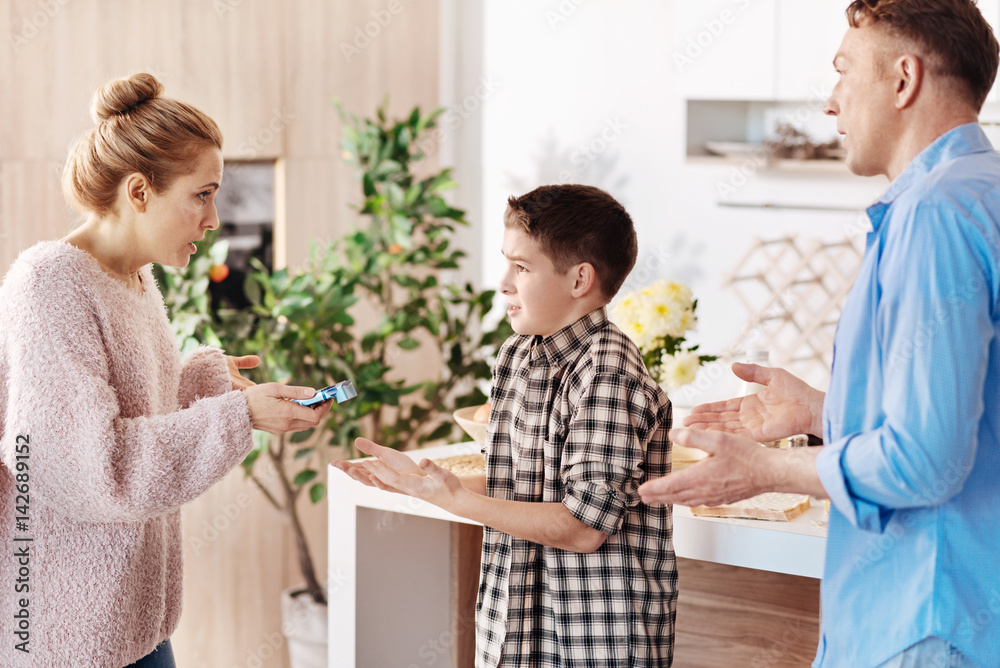 Disappointed parents scolding their son for smoking Stock Photo | Adobe ...