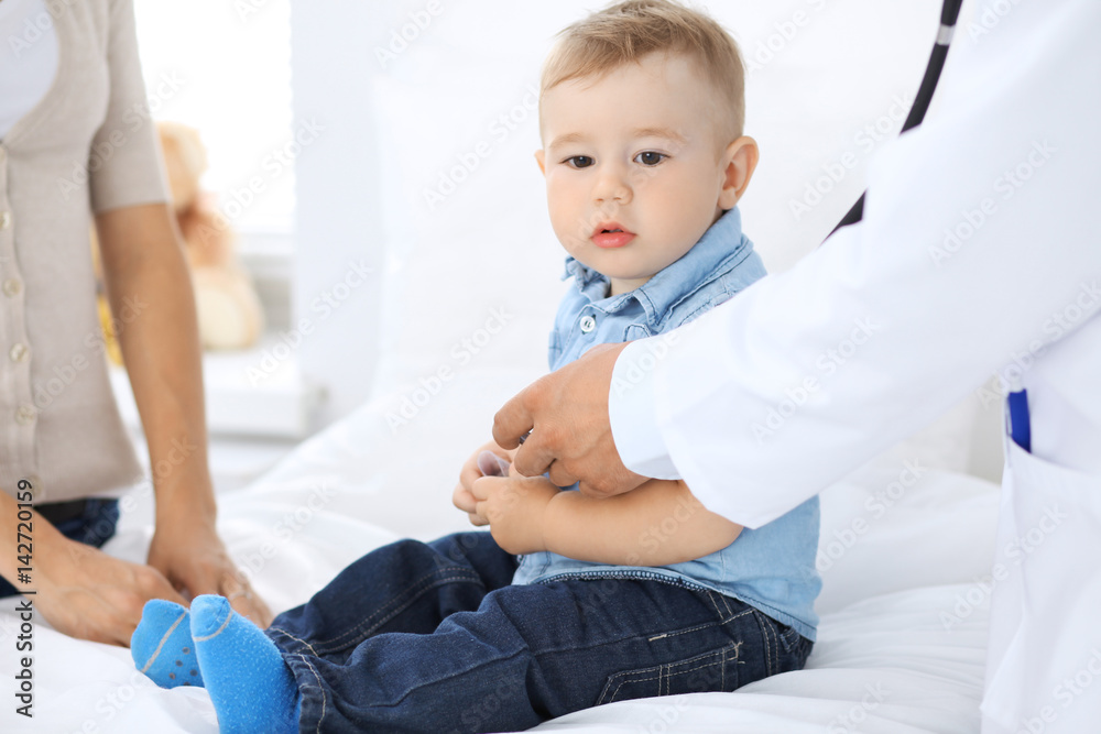 Little boy child with his mother at health exam at doctor's office ...