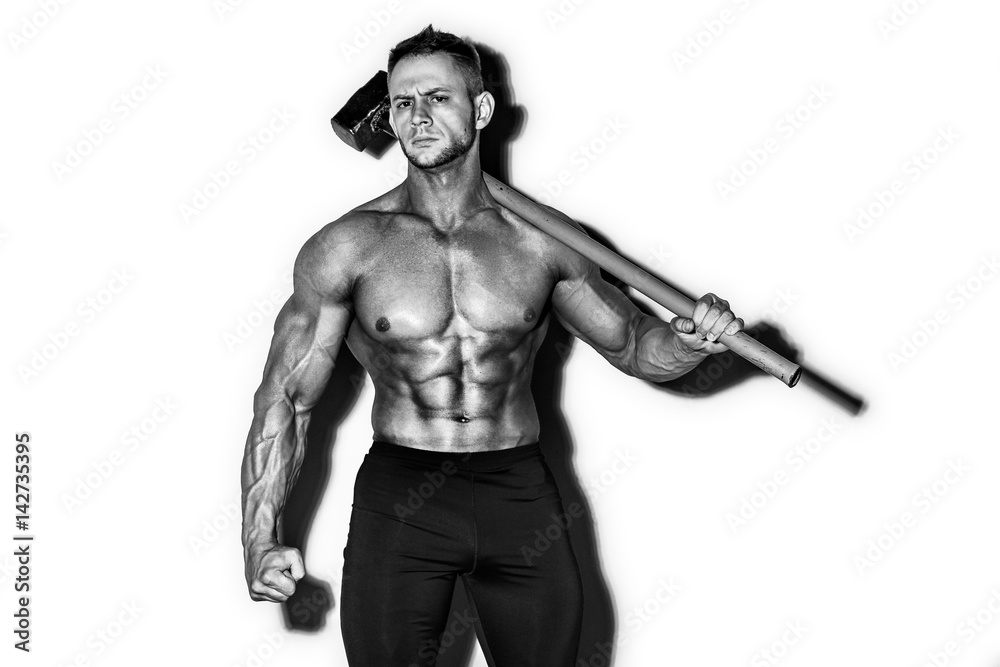 athlete and hammer. guy with a nice muscle fitness, bodybuilder hold ...