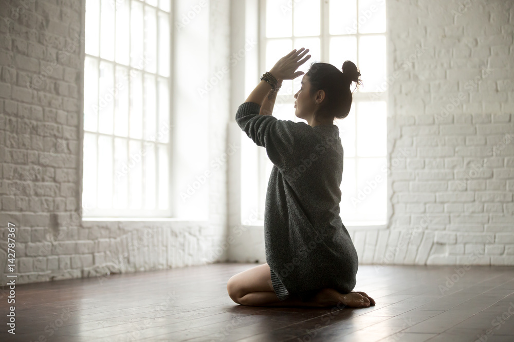 Young attractive yogi woman practicing yoga concept, sitting in ...