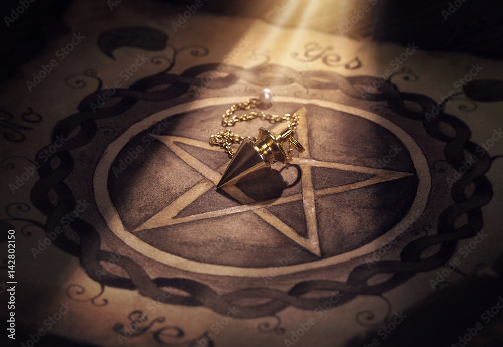 Crystal pendulum on a board Stock Photo | Adobe Stock