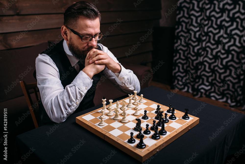 Pensive chess player thinking about game strategy Stock Photo | Adobe Stock