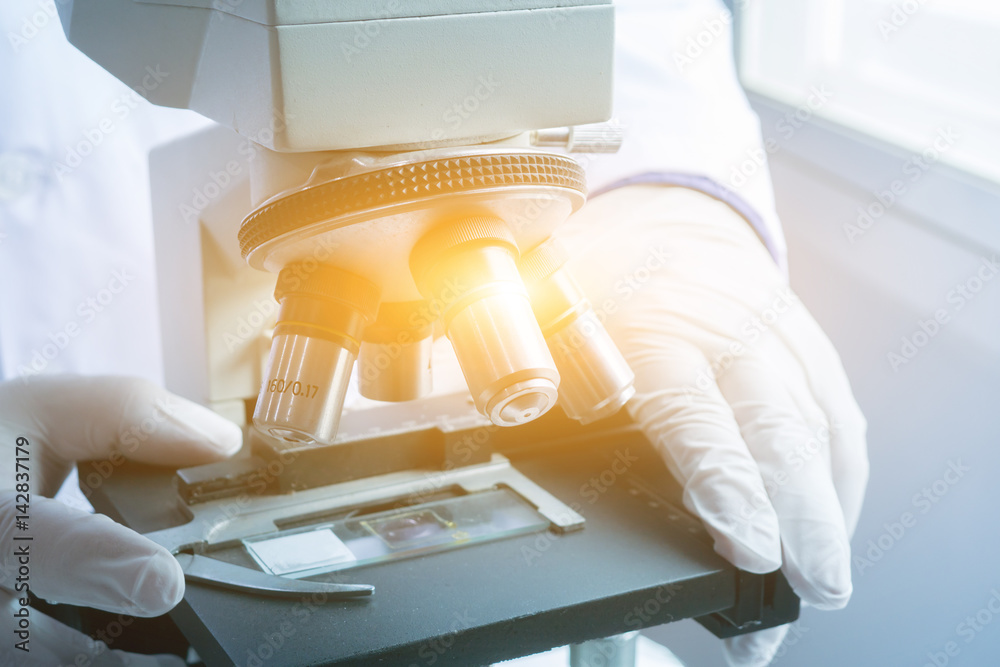 medical laboratory, scientist hands using microscope for chemistry test ...