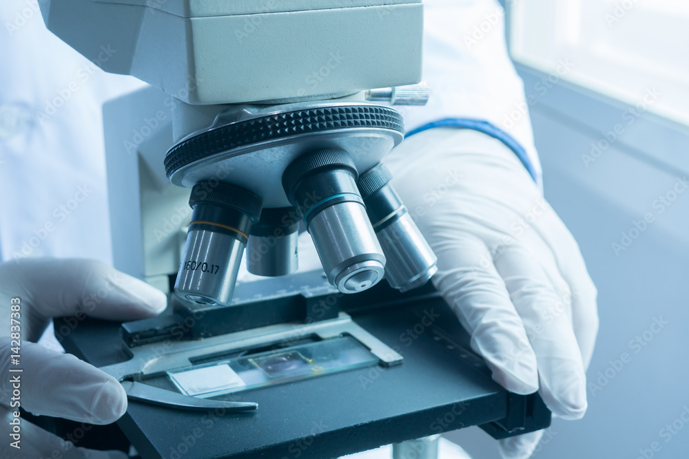 medical laboratory, scientist hands using microscope for chemistry test ...