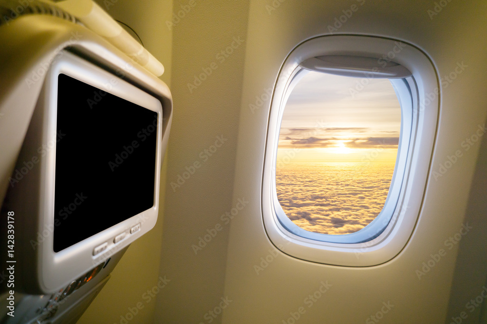 Clouds and sky as seen through window of an aircraft, plane interior ...