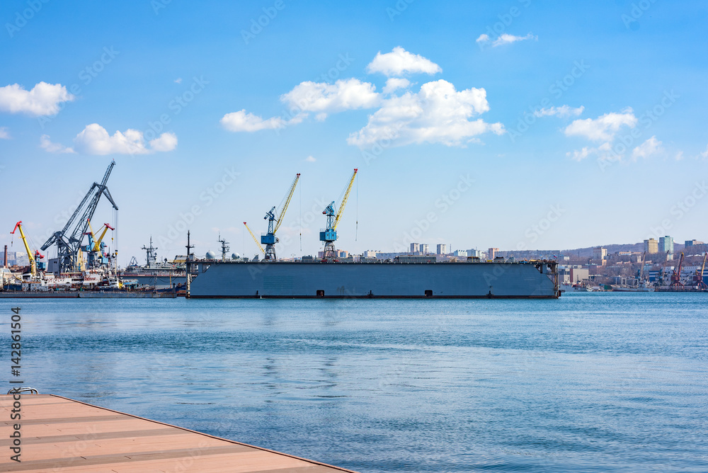 Repair of ships in the dock at the plant on the shore of the blue sea ...