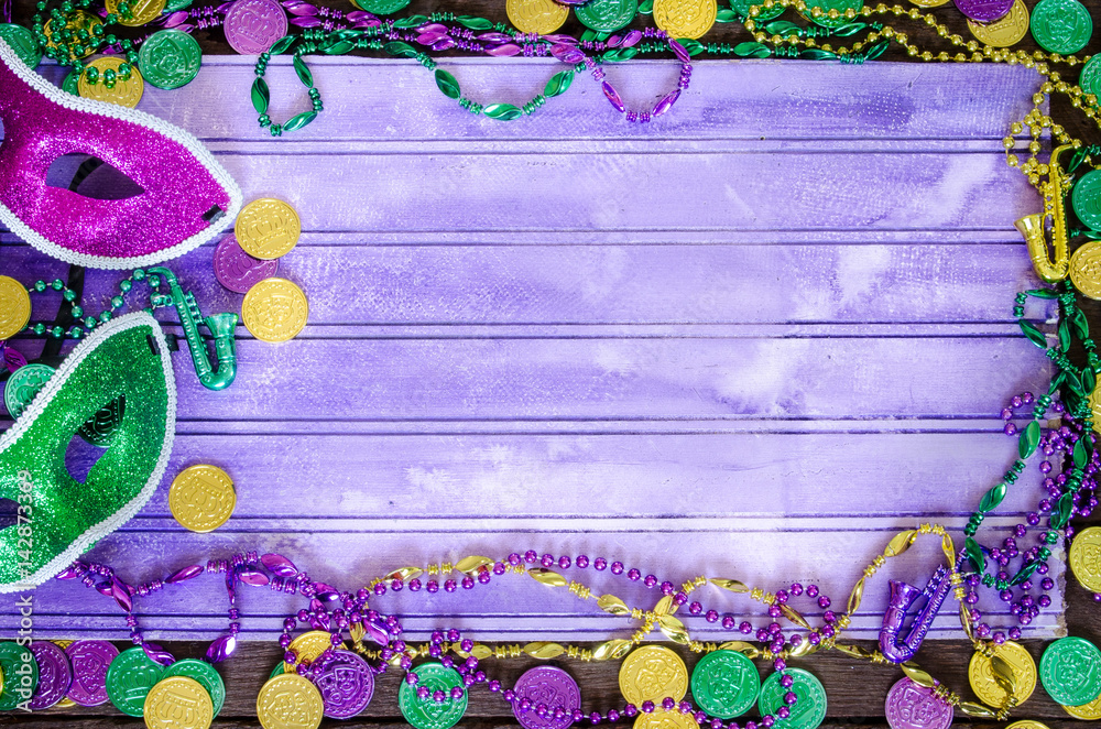 Vibrant Mardi Graw background with masks, beads and coins and copy ...