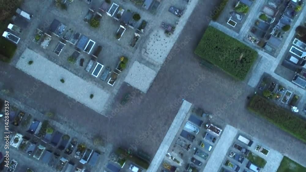 Aerial flight over cemetery also known as graveyard place where remains ...