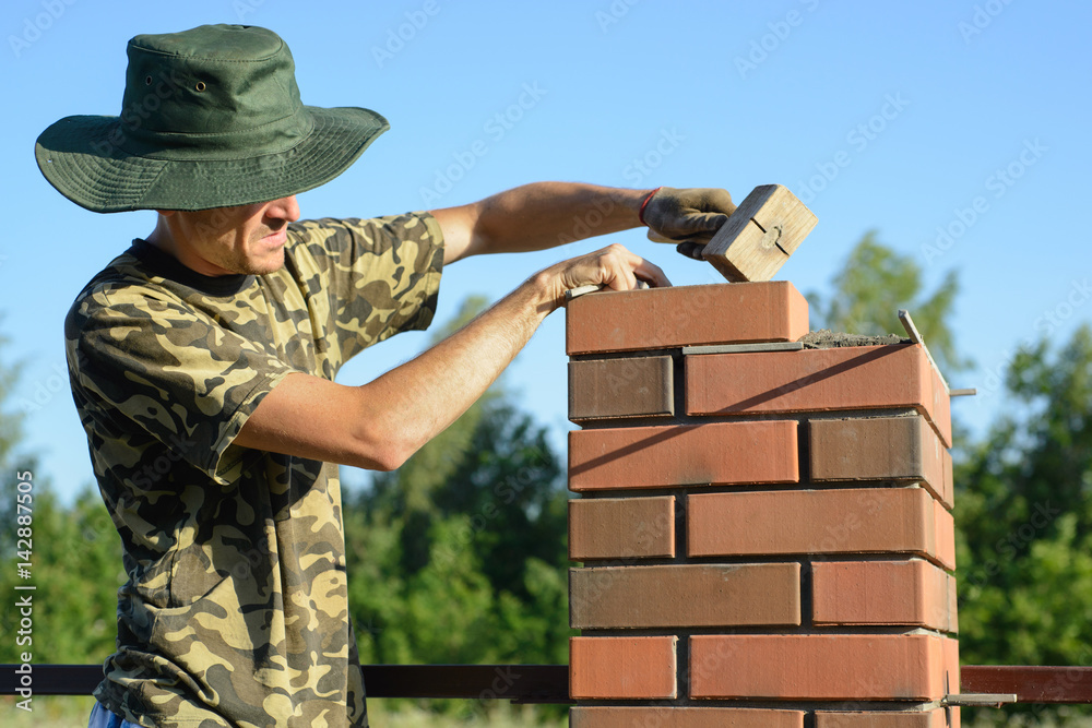 Bricklayer Worker Installing Red Clinker Blocks and Caulking Brick ...