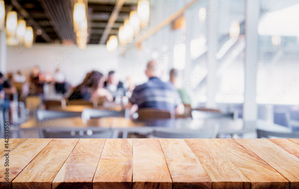 Empty of wood table top on blurred of people in coffee shop (cafe ...