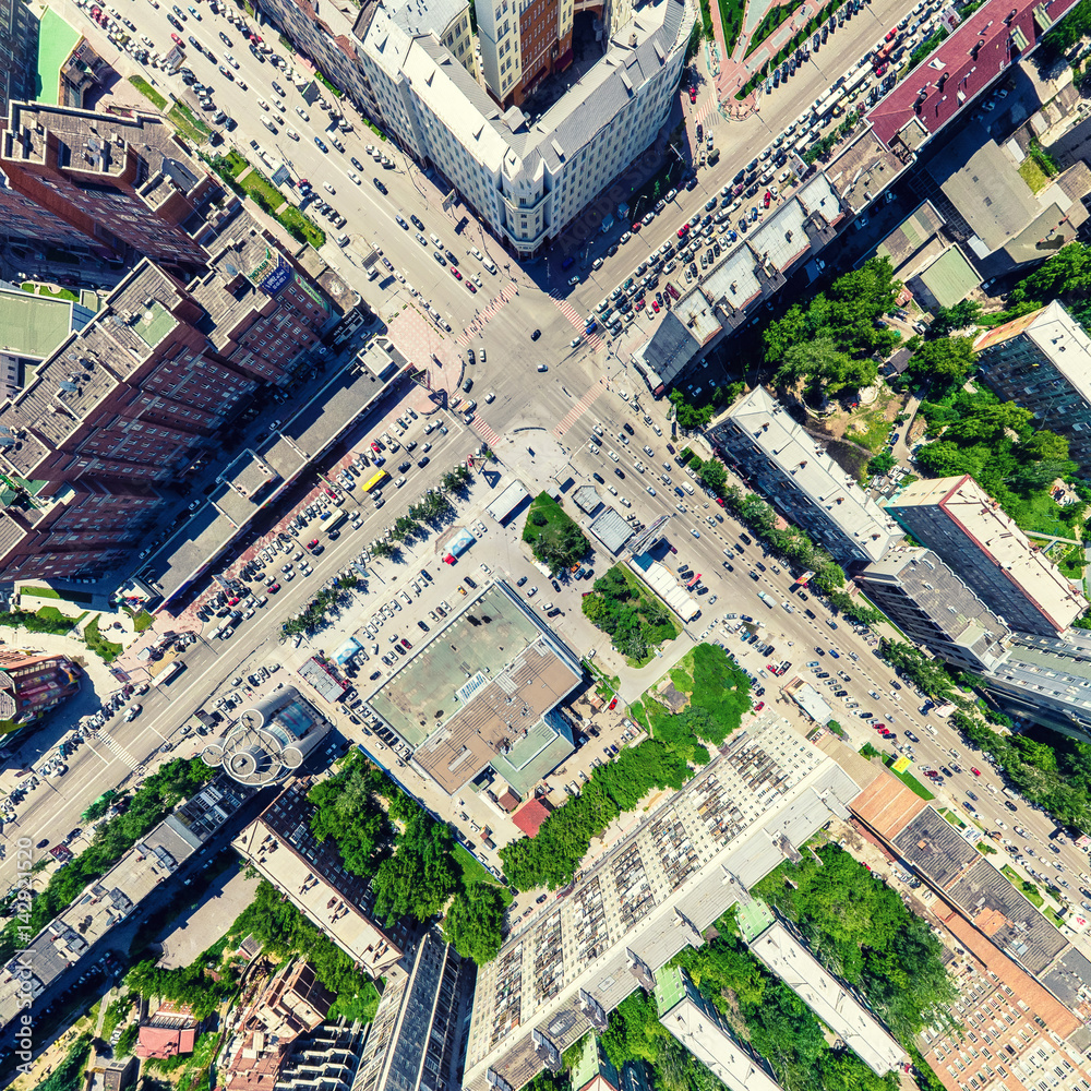 Aerial city view with crossroads and roads, houses, buildings, parks ...