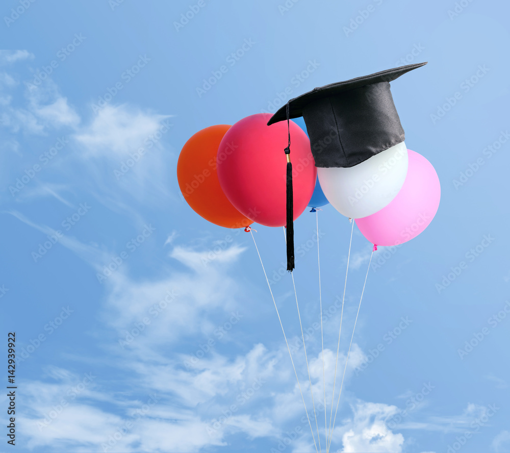 congratulations graduates on top of Balloons with blue sky background ...