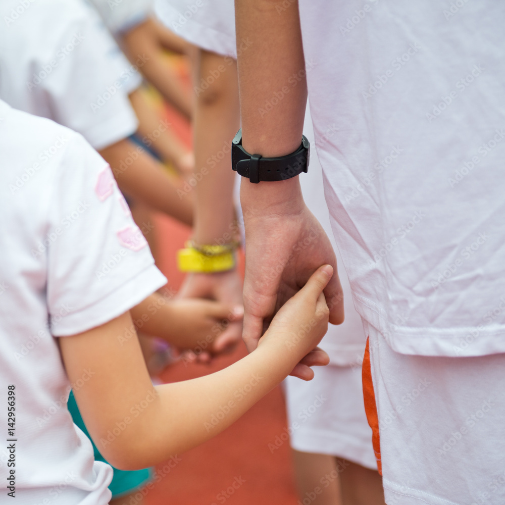 Group of children holding hands together.. Stock Photo | Adobe Stock