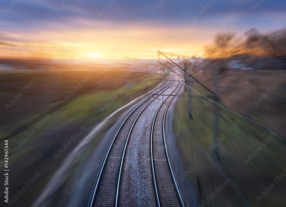Railroad in motion at sunset. Railway station with motion blur effect ...