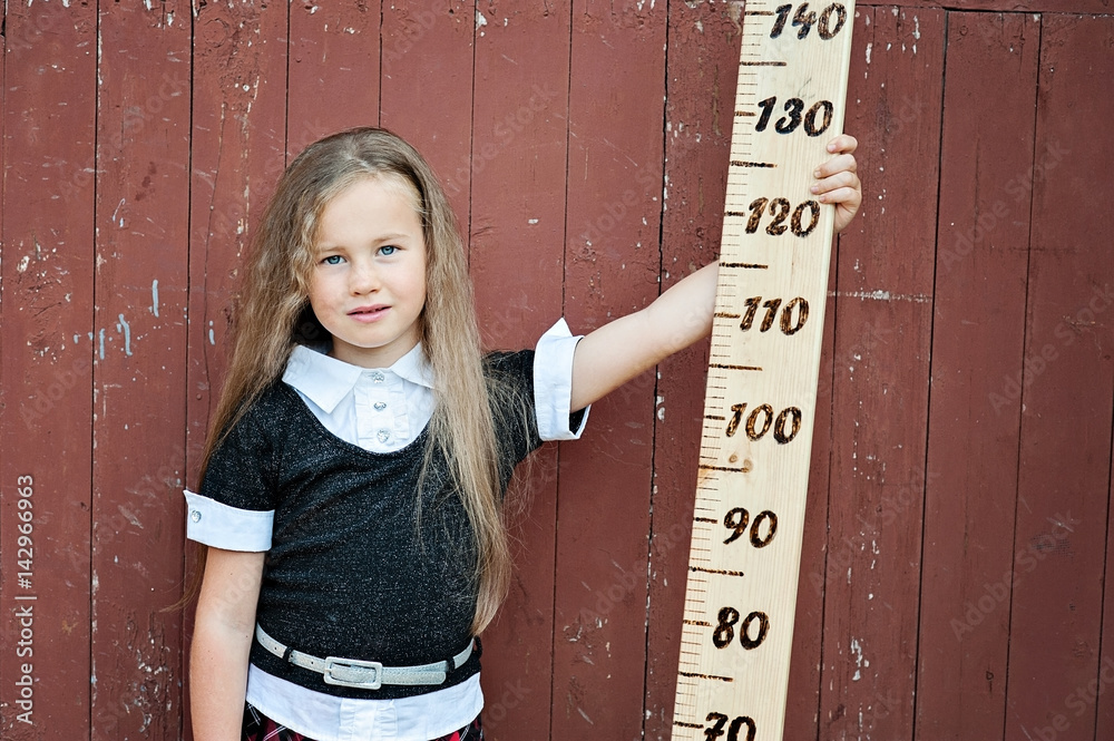 girl with big ruler Stock Photo | Adobe Stock