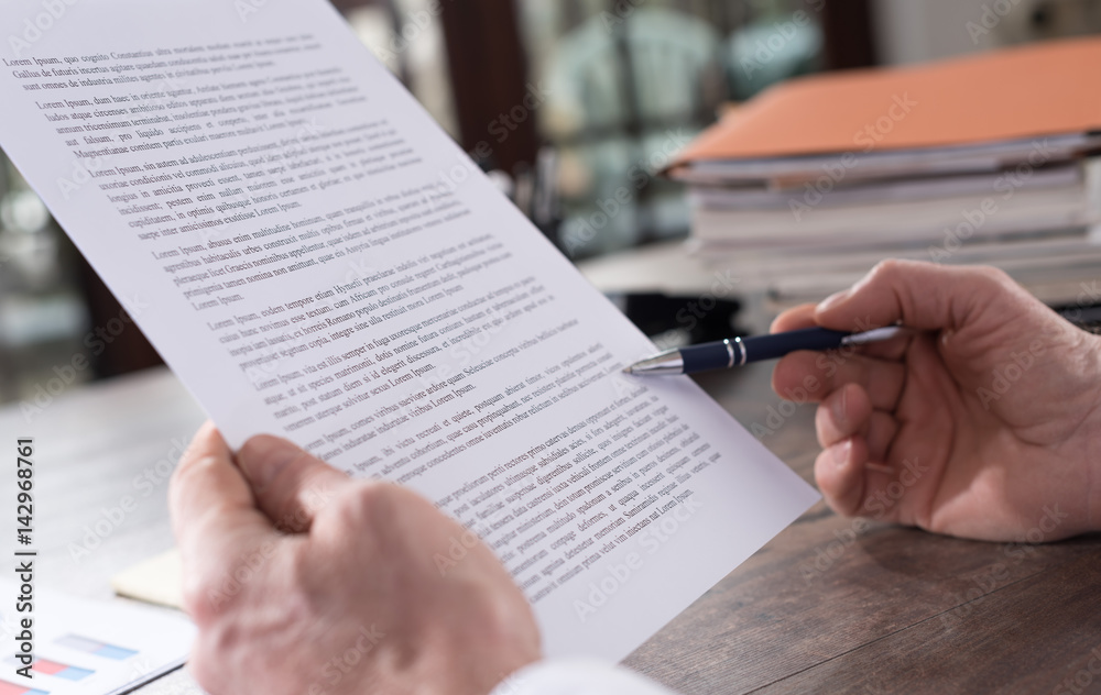 Checking a document Stock Photo | Adobe Stock