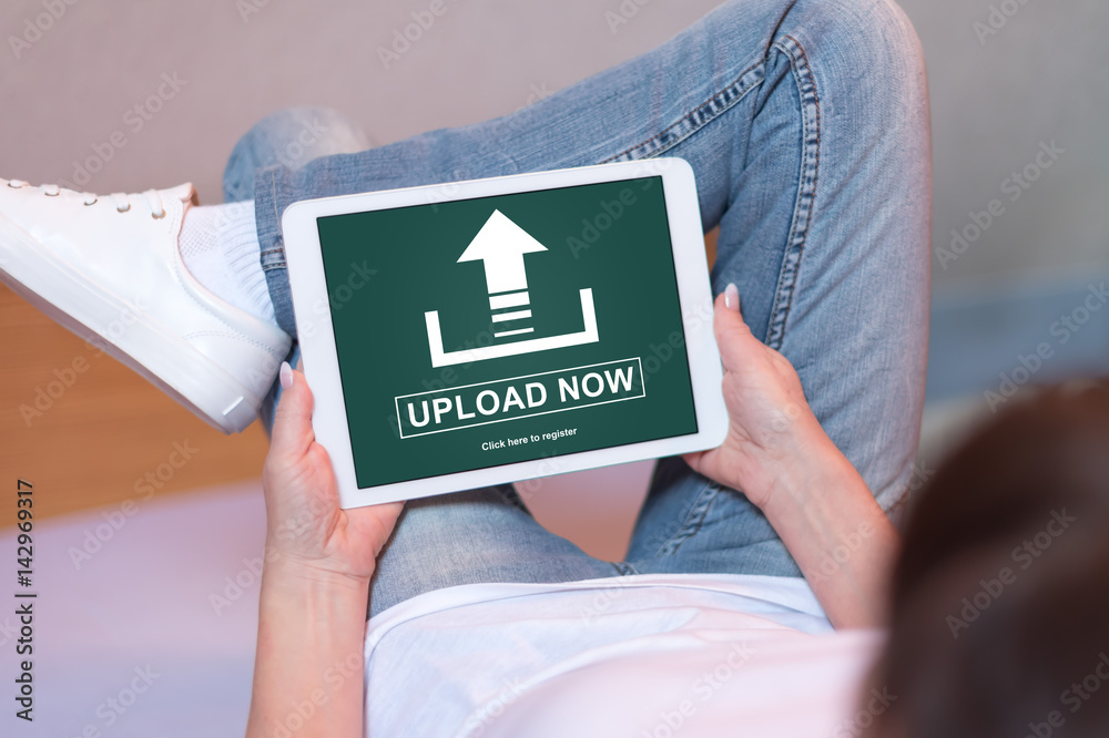 Upload concept on a tablet foto de Stock | Adobe Stock