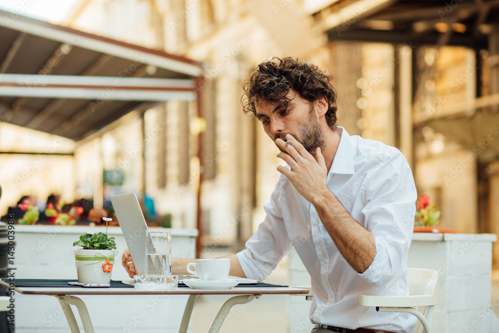 handsome elegant man sitting outside ar terrace and smoking Stock Photo ...