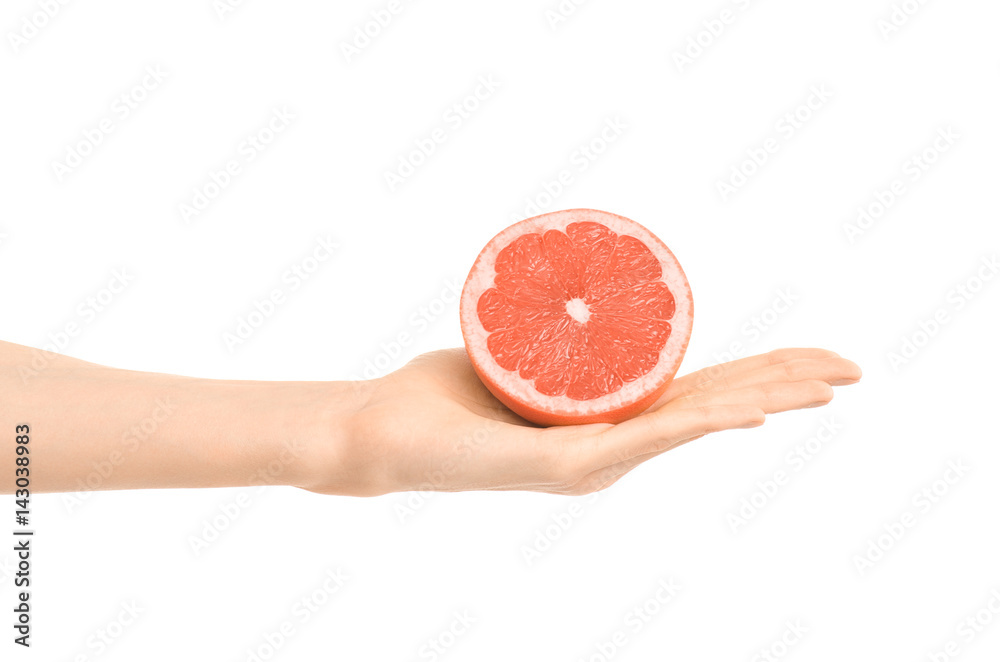 Healthy eating and diet Topic: Human hand holding a half of grapefruit ...