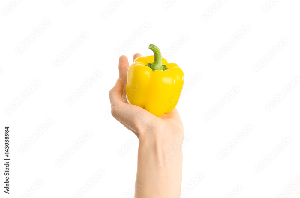 Healthy eating and diet Topic: Human hand holding yellow pepper ...