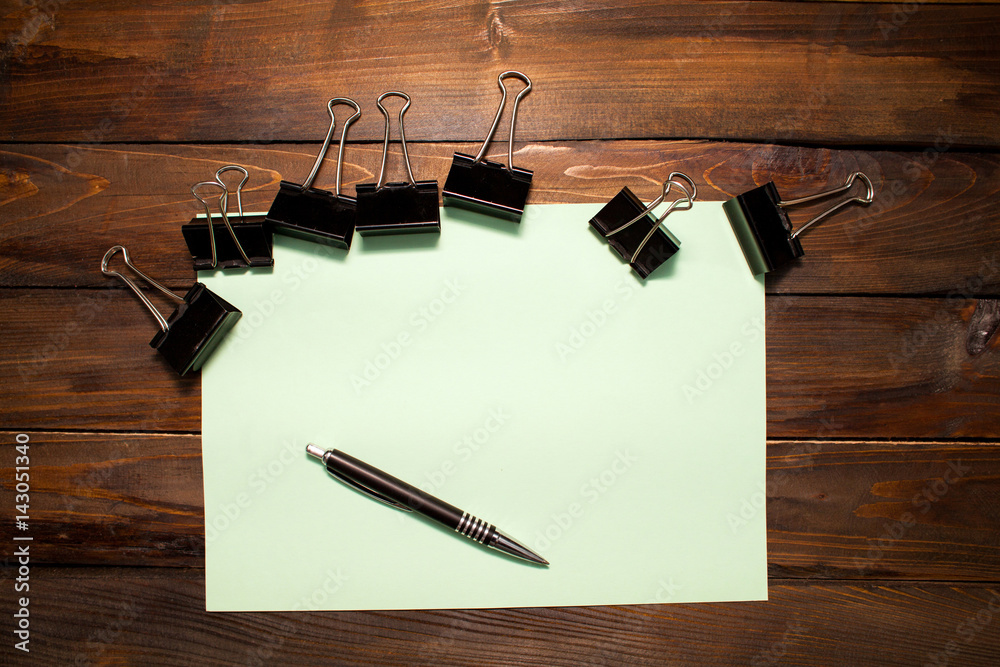 Black paper clamps for paper with sheet of A4 paper and handle on ...