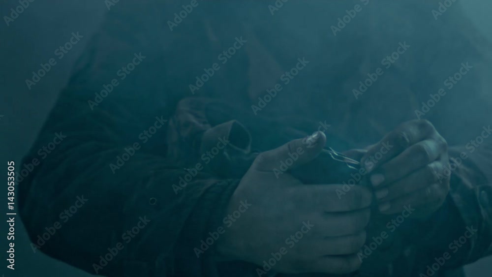 Loading bullet cartridge. Soldier man take bullet from helmet and ...