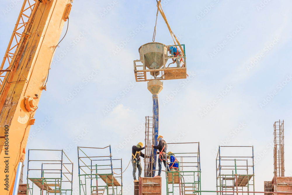 Construction workers working on scaffolding at a high level by the ...