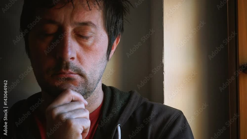 Vídeo do Stock: Sad and hopeless man thinking by the bedroom window ...