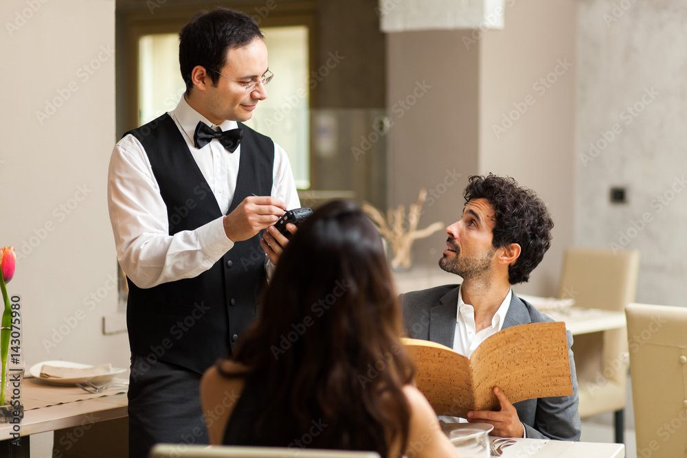 Couple having dinner in a luxury restaurant Photos | Adobe Stock