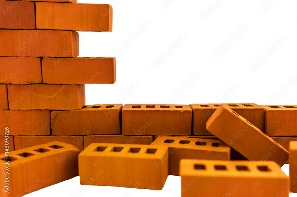 Bricks near the wall. Unfinished brick wall. Photos | Adobe Stock