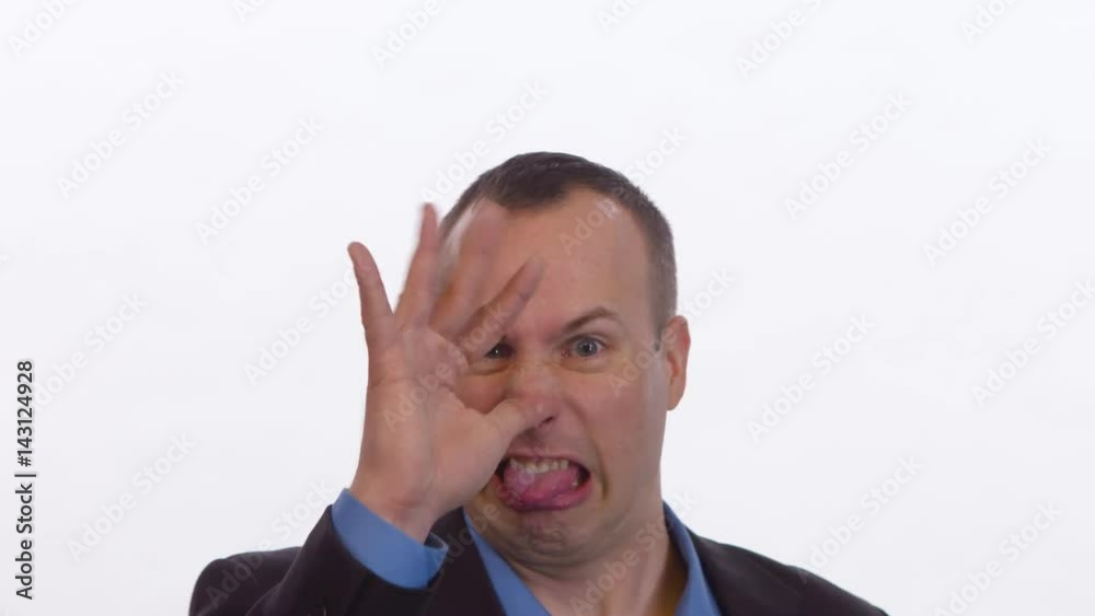Man makes silly faces and mocks camera on a white background. Stock ...