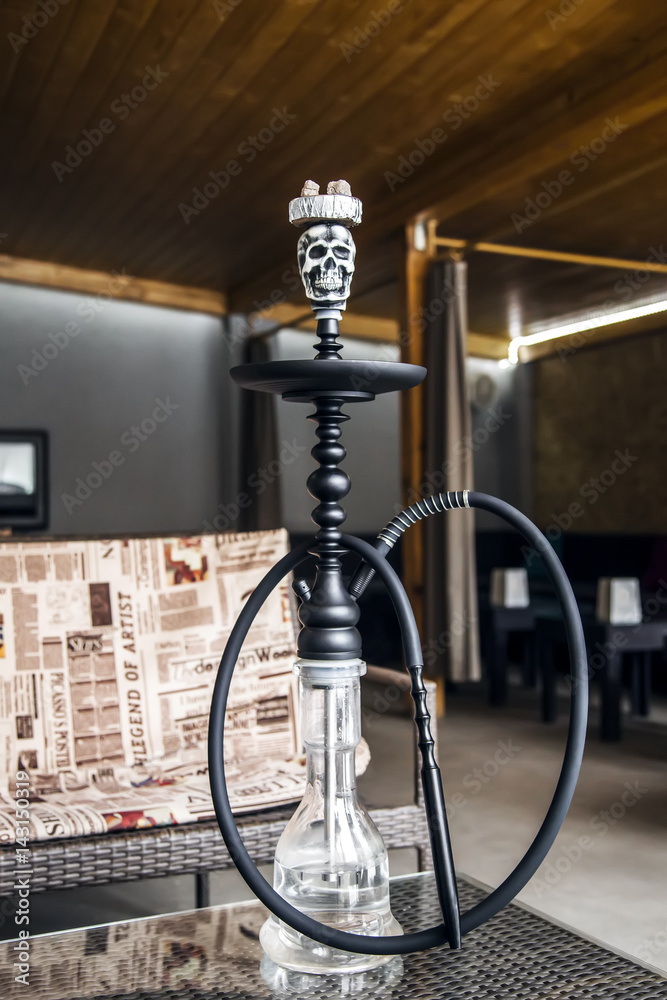 Black hookah on grey interior with skull Stock Photo | Adobe Stock