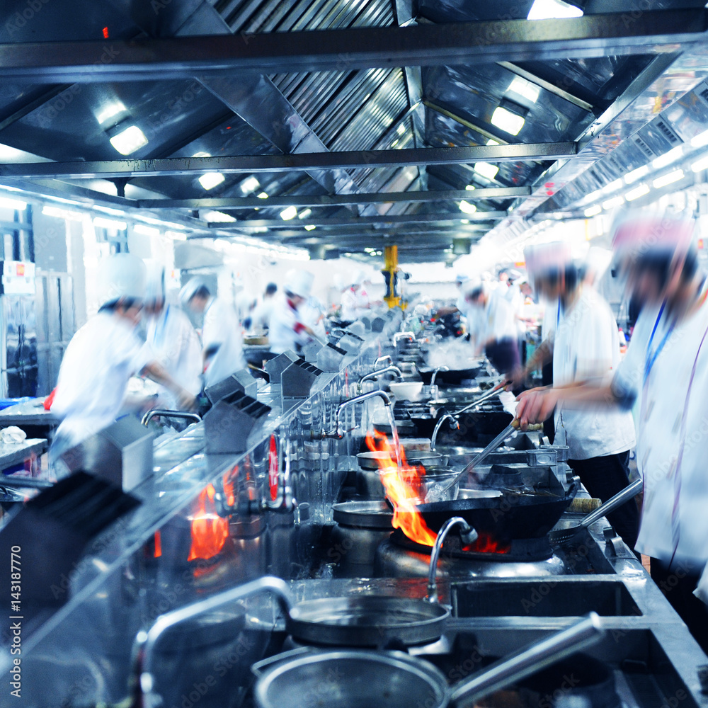 Motion chefs in a Chinese restaurant kitchen. Stock Photo | Adobe Stock