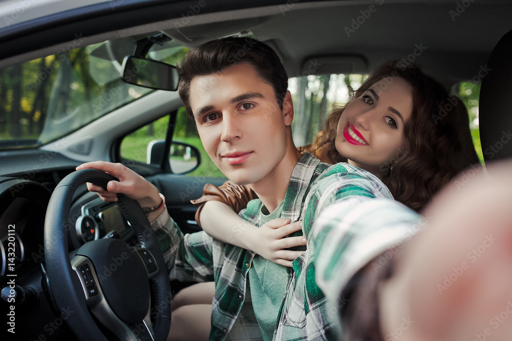 young couple having fun inside a car and making selfie Stock Photo ...