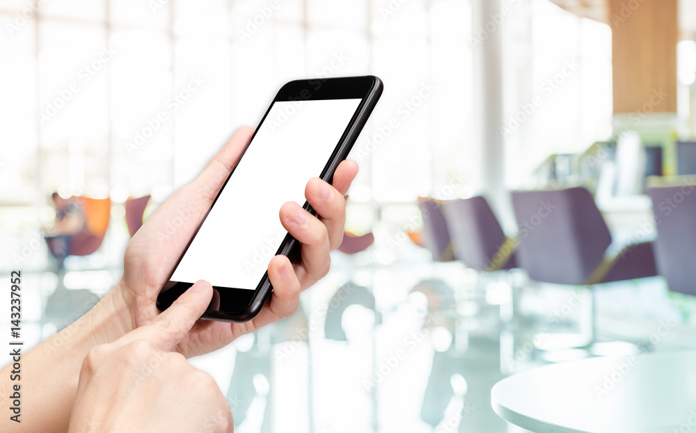Hand click mobile phone with blur bank counter background bokeh light ...