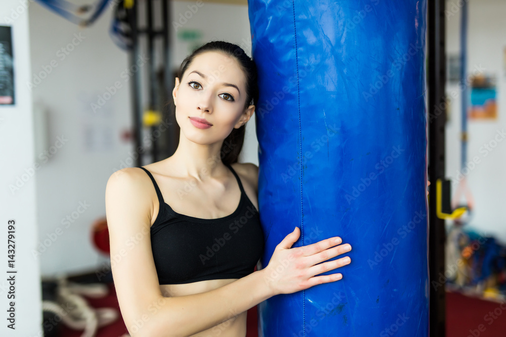 fighter girl in gym with boxing bag. Long hair woman fitness ufc model ...